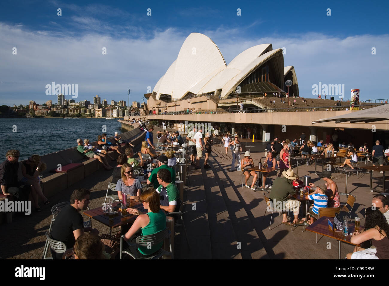 People enjoying waterfront drinks at the Opera Bar, at the foot of the ...