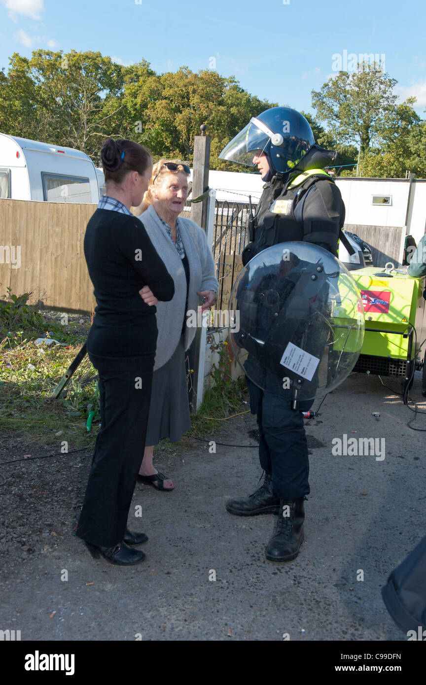 Residents talk to a police officer - After ten years of court battles ...