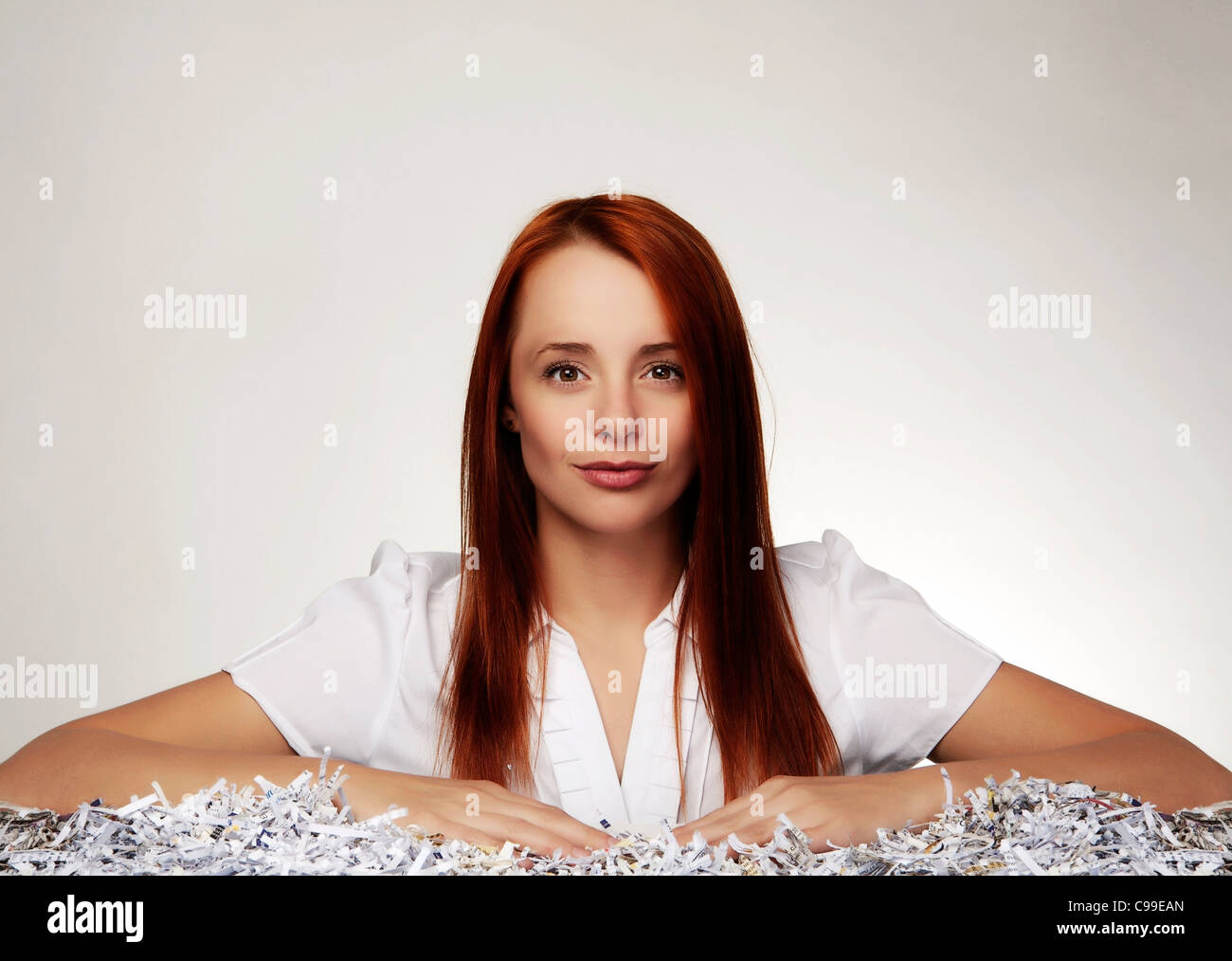 woman with a pile of shredded paper in front of her on her desk Stock ...