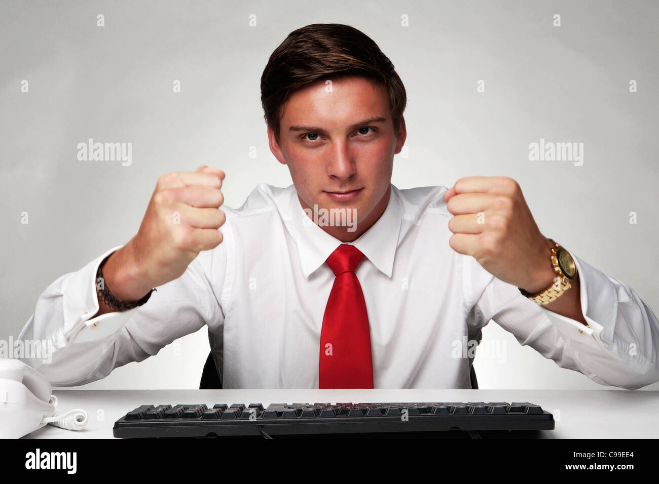 business man at hitting his desk and not very happy about something ...