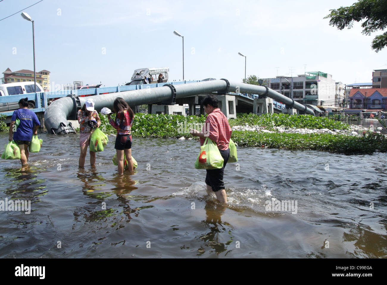 People wading in floodwaters , Pathum Thanni Province, Thailand Stock ...
