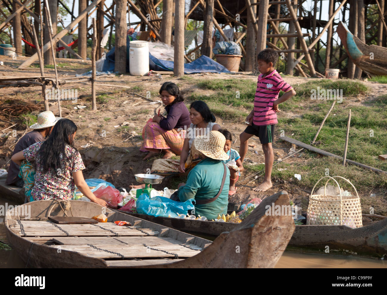 A group of local women are buy fruits and vegetables on boat, floating ...