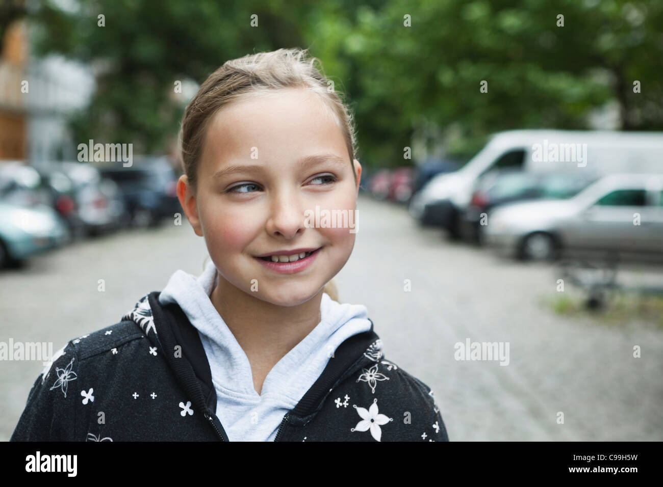 Germany, Berlin, Girl standing in street, smiling Stock Photo - Alamy