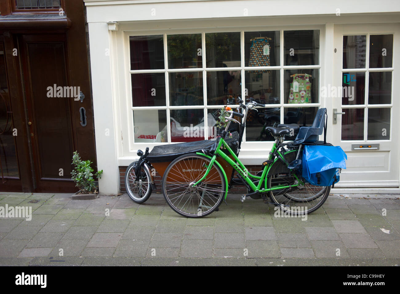 Cycles parked outside a shop in Amsterdam, Netherlands Stock Photo - Alamy