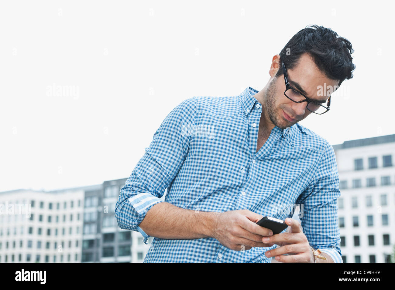 Germany, Berlin, Man using cell phone in city Stock Photo - Alamy