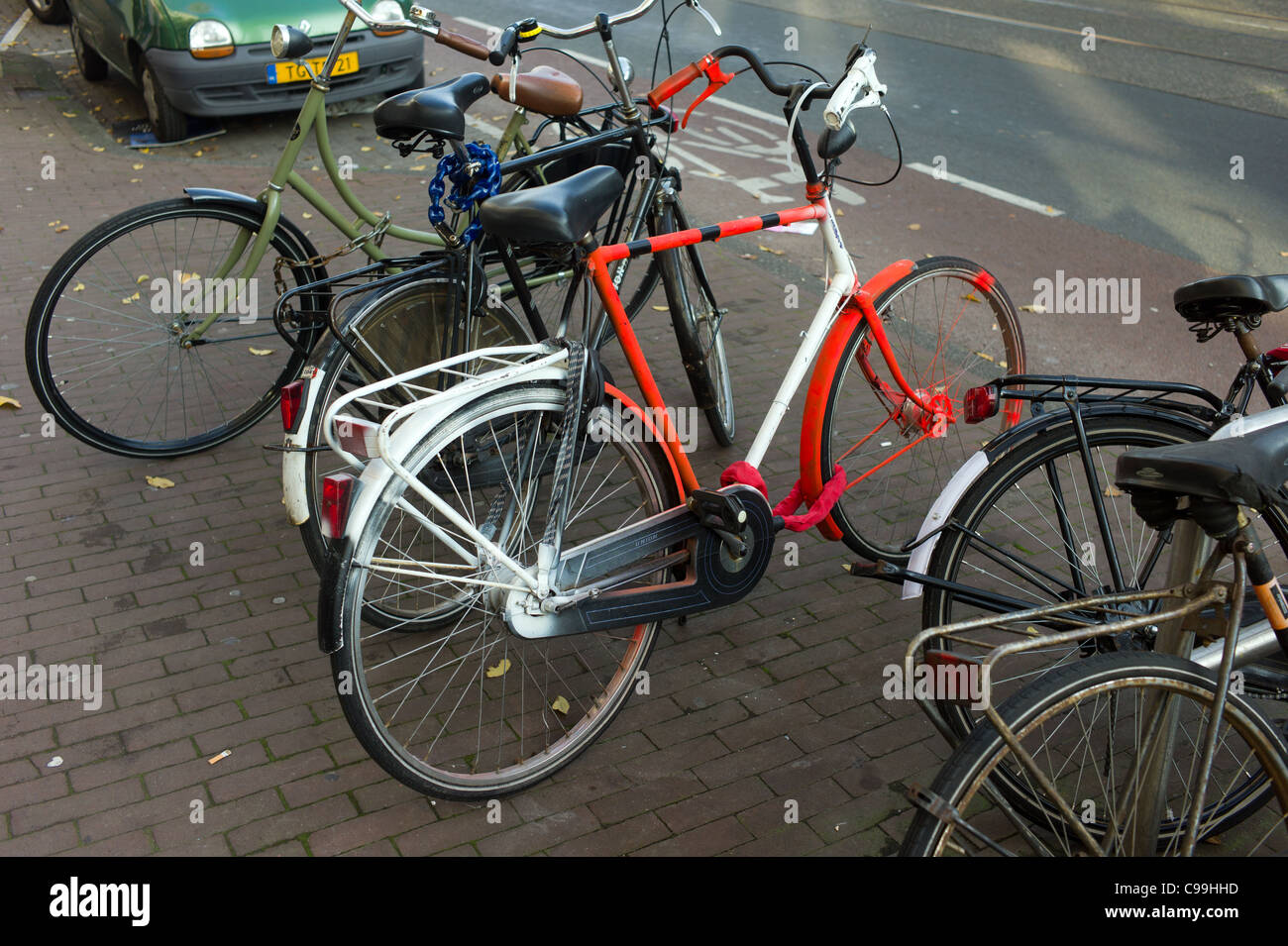 Pimped and painted orange bike parked on Damrak in Amsterdam ...