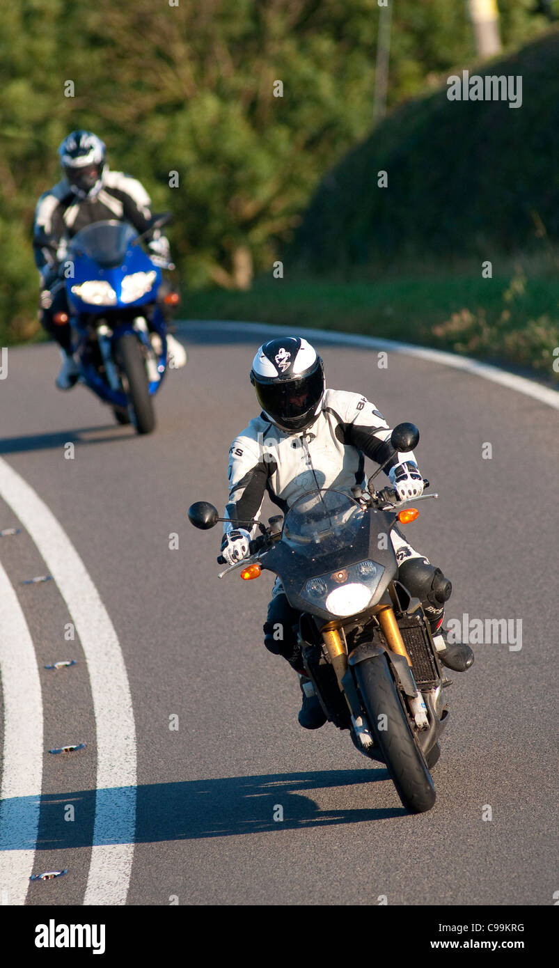 Motorcyclists riding along a rural road in England Stock Photo - Alamy