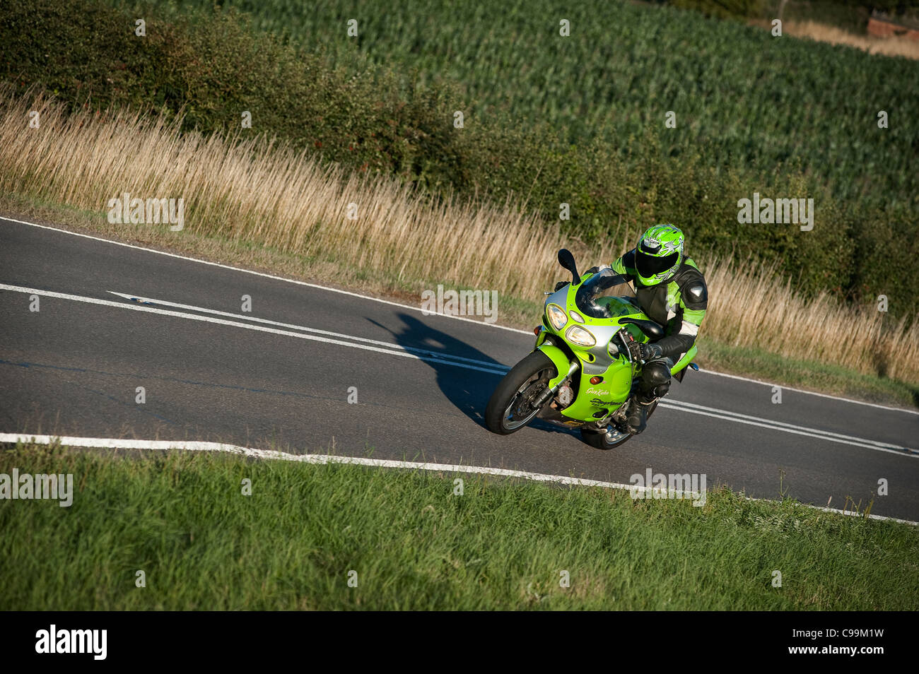 Motorcyclist riding along a rural road in England Stock Photo - Alamy
