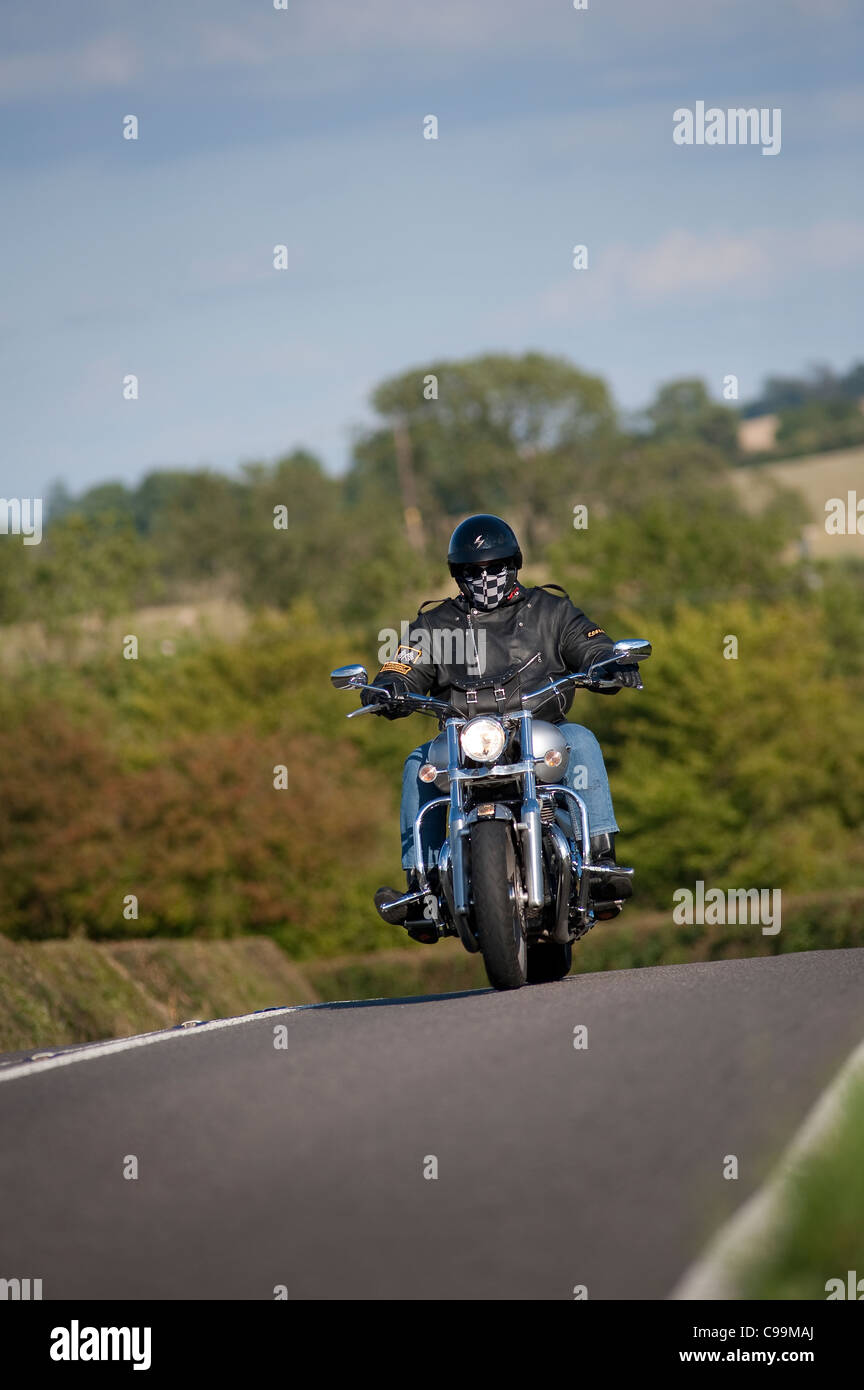 Motorcyclist riding along a rural road in England Stock Photo - Alamy