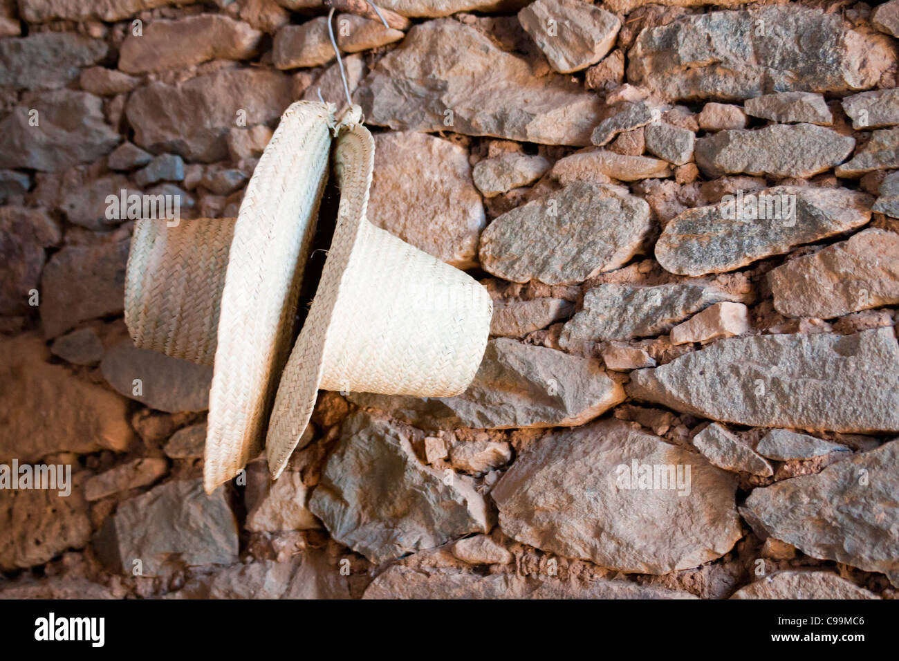 Hats hanging on a stone wall inside the shack that contains King Ezana ...
