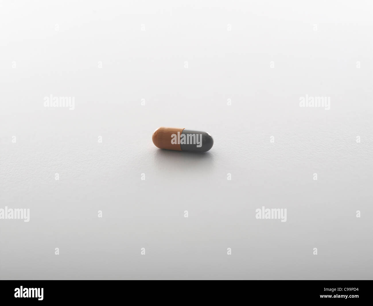 Single pill on white background Stock Photo - Alamy