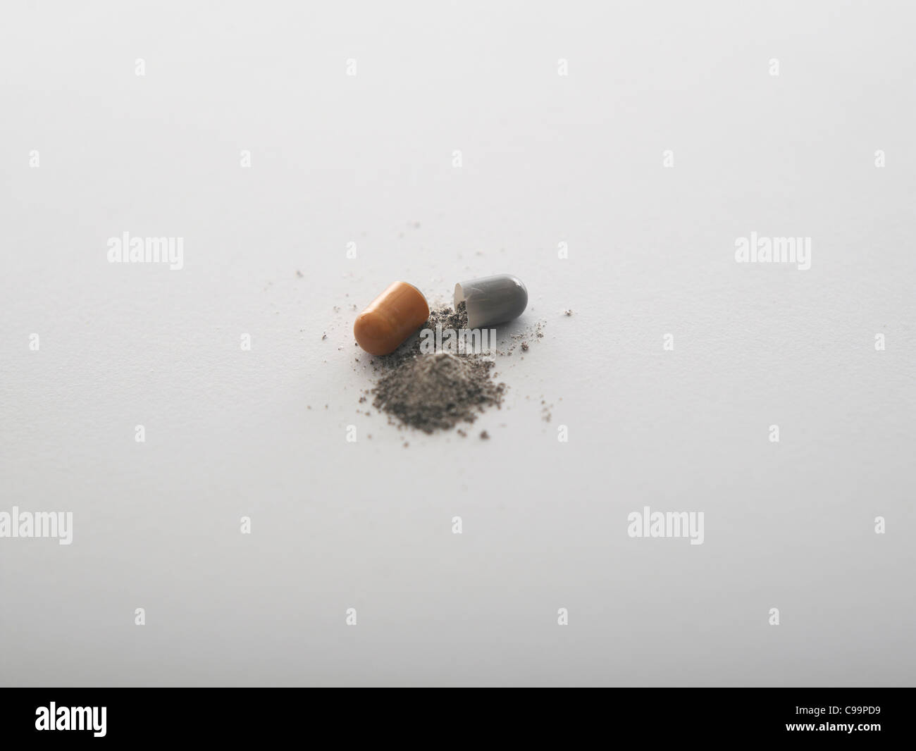 Open pill on white background Stock Photo - Alamy