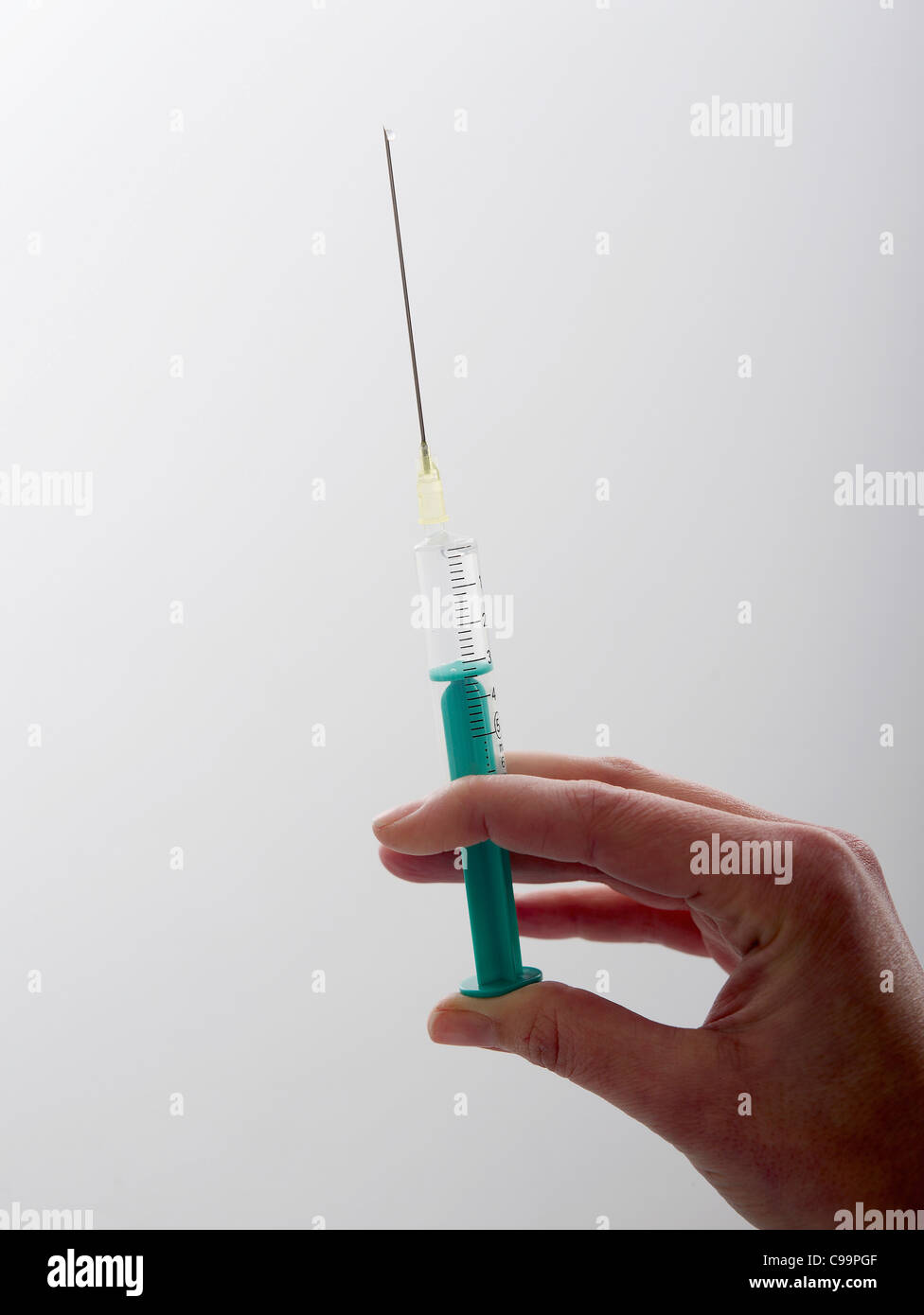 Human hand holding syringe, close up Stock Photo - Alamy
