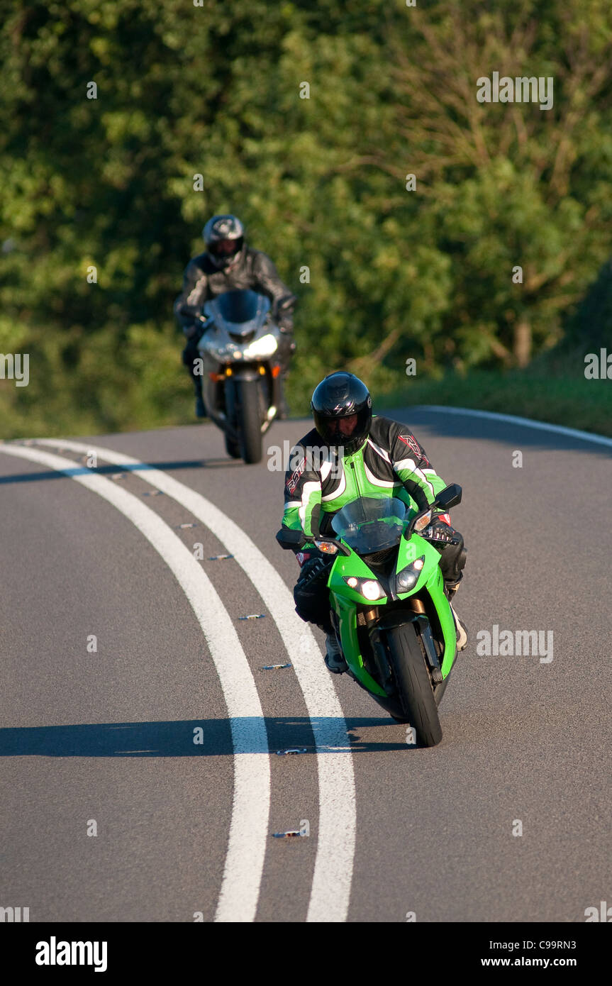 Motorcyclist riding along a rural road in England Stock Photo - Alamy