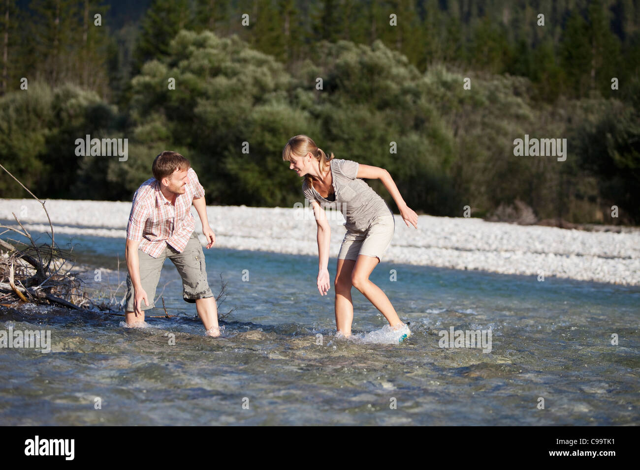 Germany, Upper Bavaria, Couple having fun in river Stock Photo - Alamy