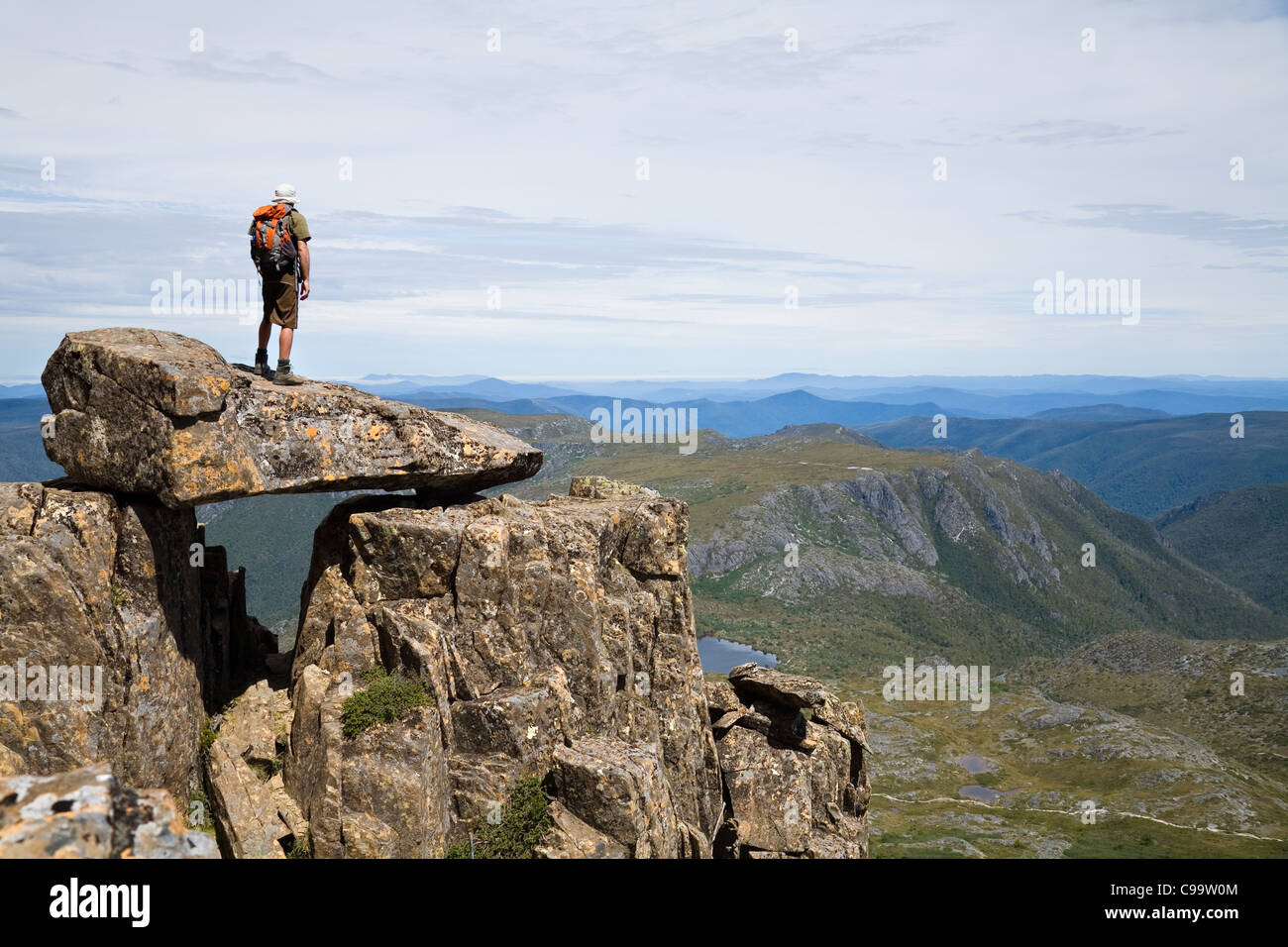 Hiker atop Cradle Mountain in Tasmania's central highlands. Cradle ...