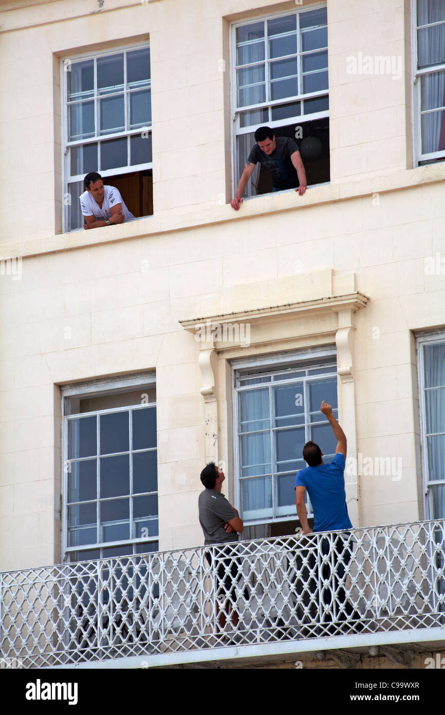 Man talk - having a conversation from different windows in house at ...