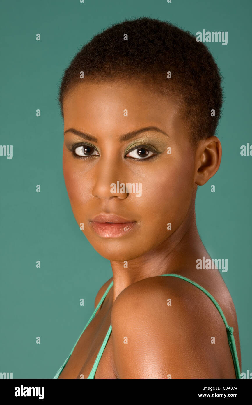 Portrait of young beautiful Afro American woman with short hair wearing ...