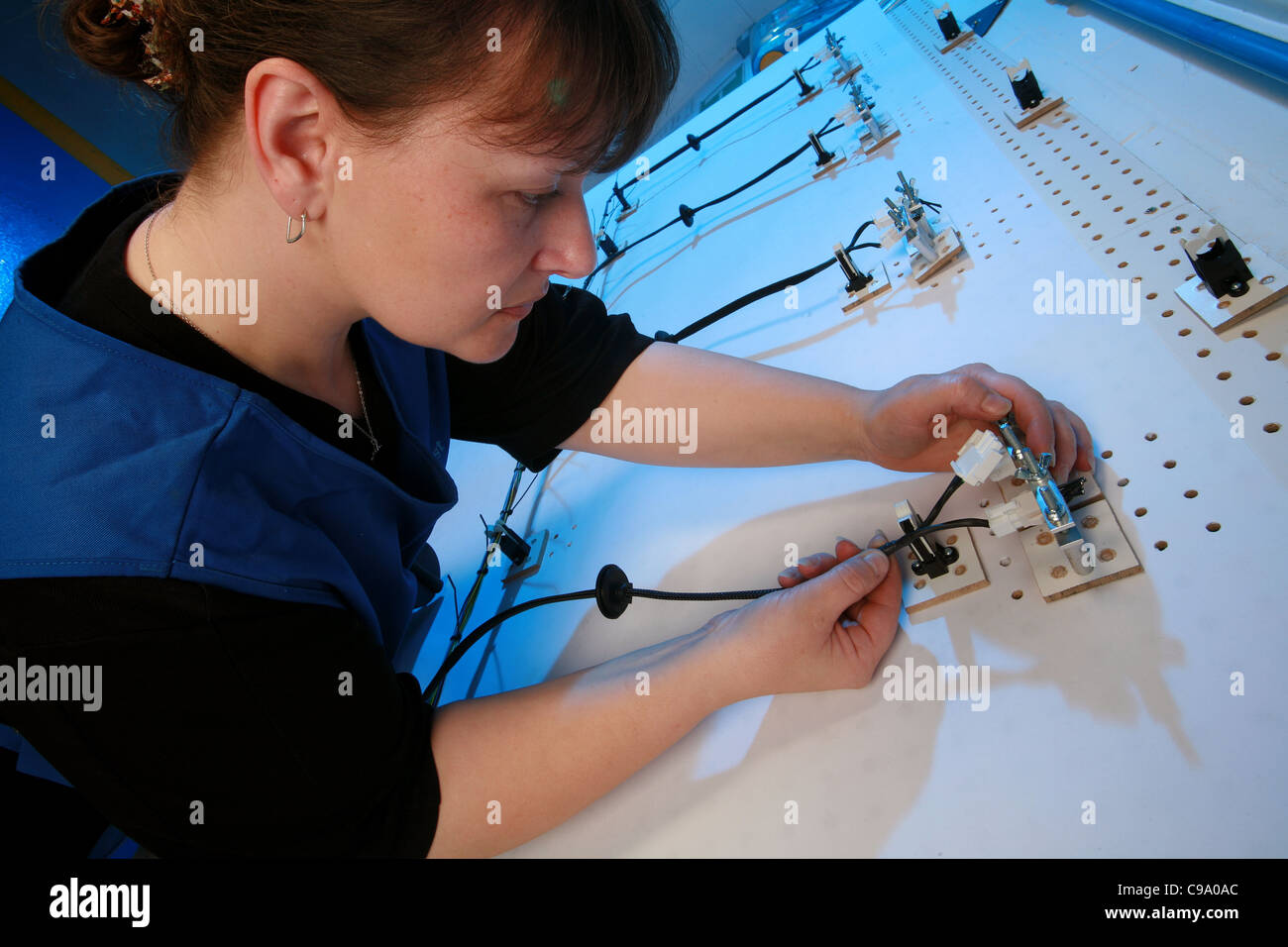 woman working on wiring loom Stock Photo - Alamy
