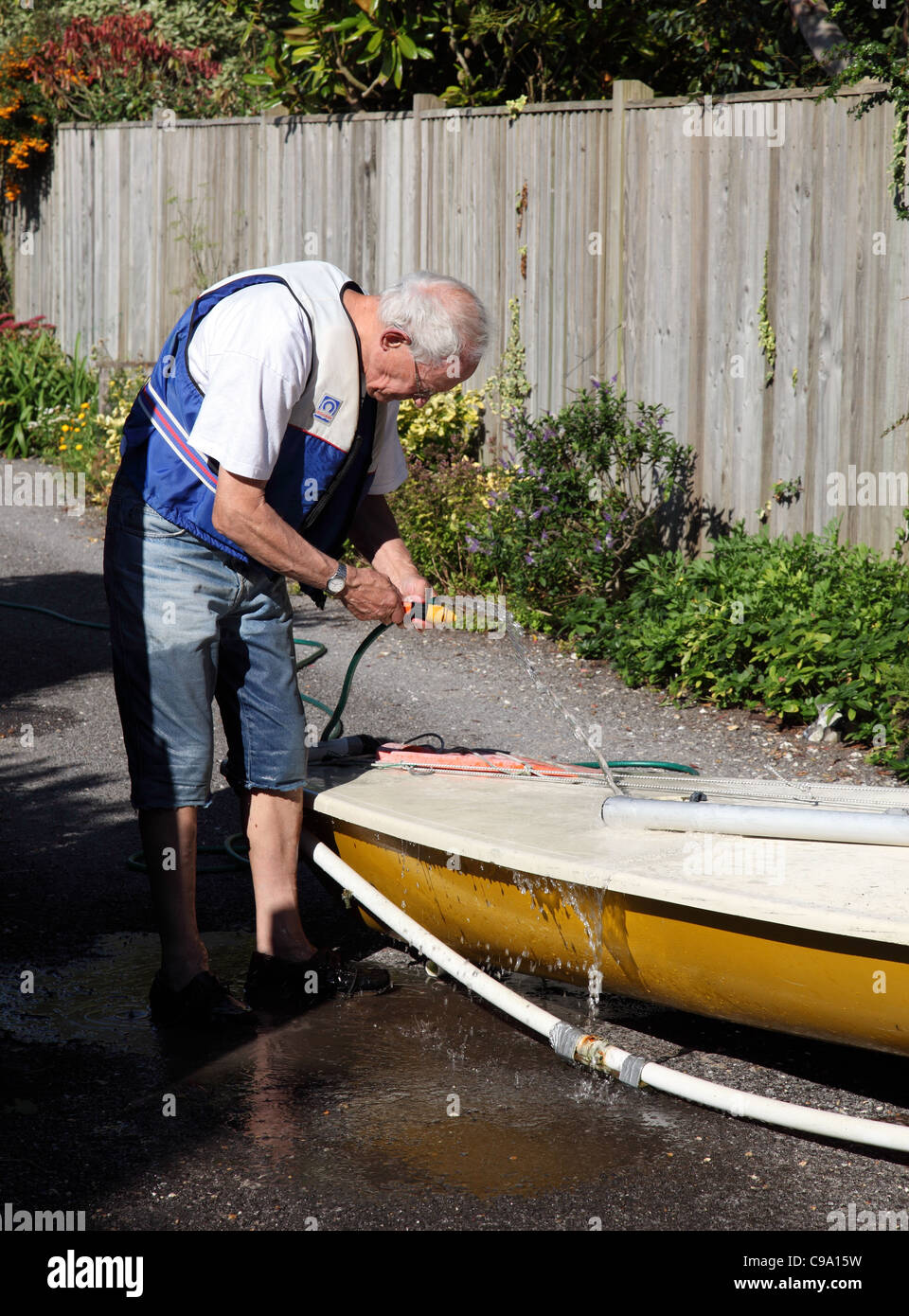 Washing salt water off boat Stock Photo - Alamy
