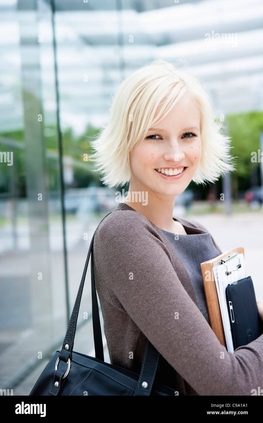 Germany, Munich, Young woman smiling, portrait Stock Photo - Alamy