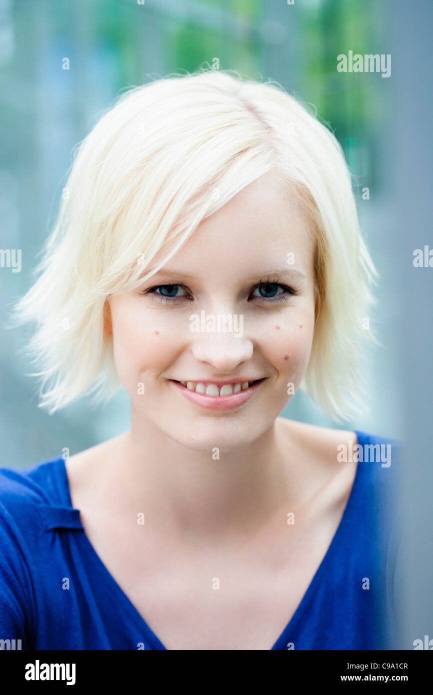 Germany, Bavaria, Munich, Young woman smiling, portrait Stock Photo - Alamy