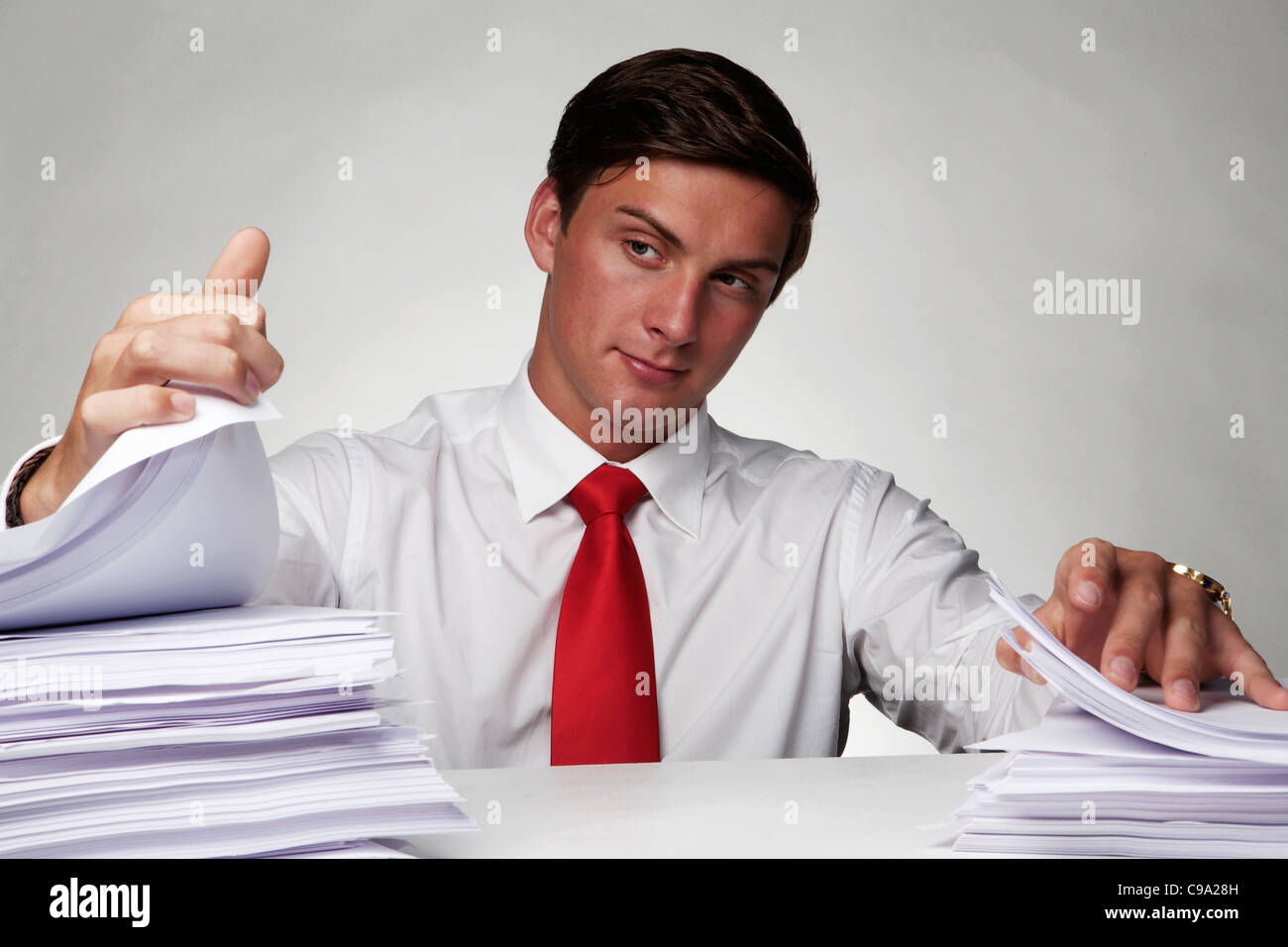 business man at his desk at work with lots of paper work to do Stock ...
