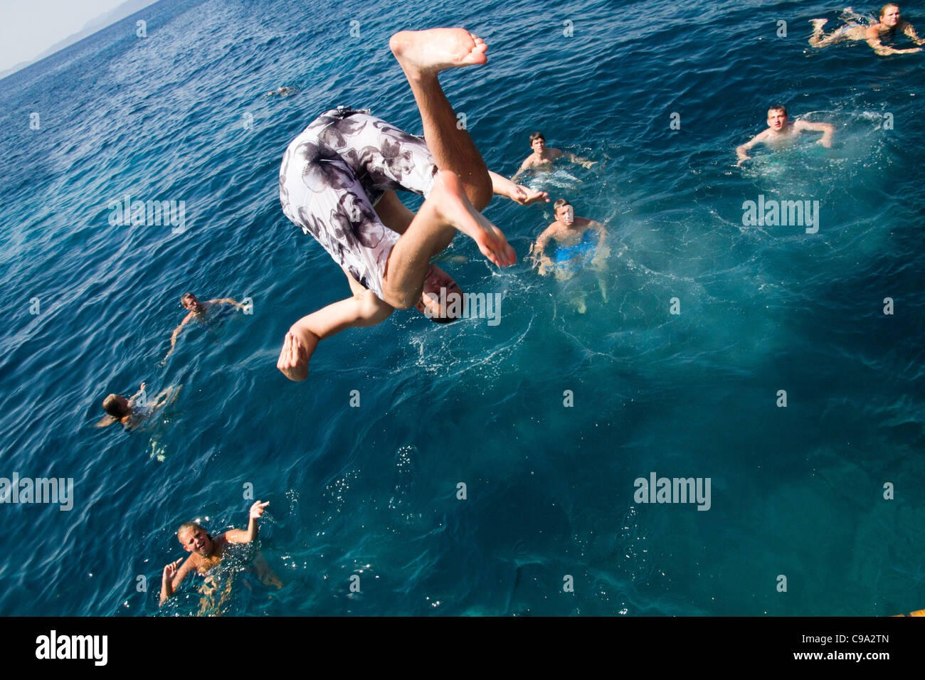 Young man Jumping funny into the sea water Mallorca Majorca Balearic ...