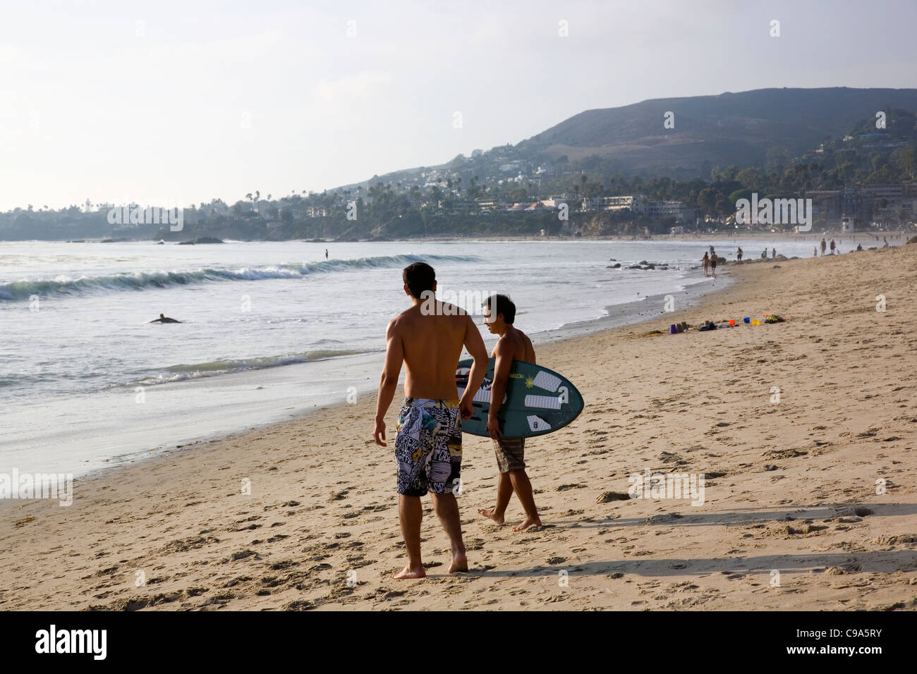 Two guys on Laguna Beach about to skimboard - California Stock Photo ...
