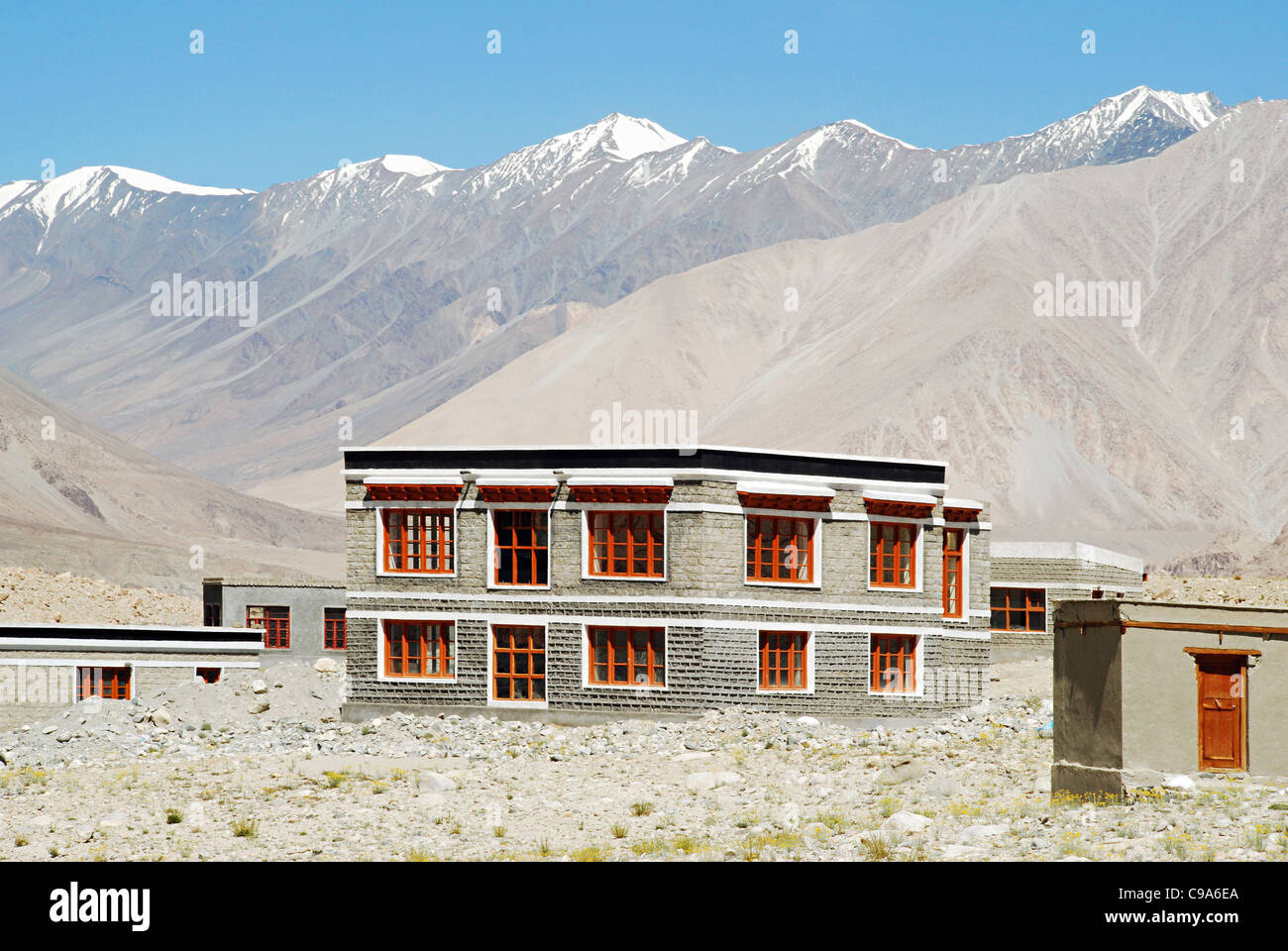 A building under construction. Snow clad Himalayan Mountain Ranges in ...