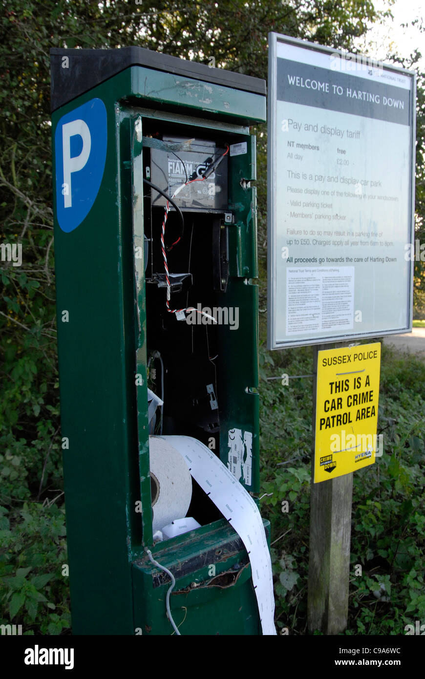Vandalised car park ticket machine with theft warning sign Stock Photo ...