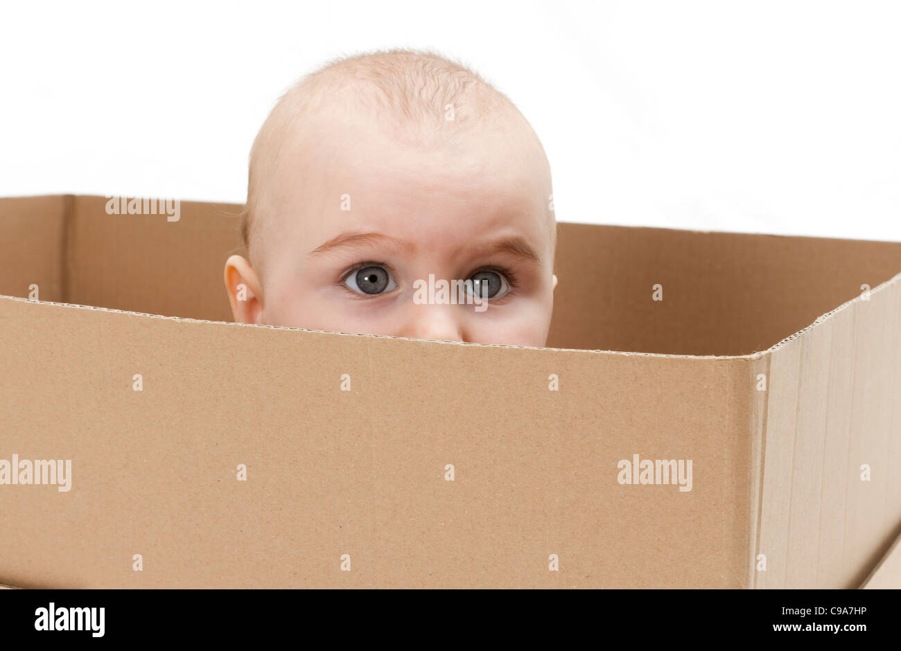 young child looking out of open cardboard box Stock Photo - Alamy