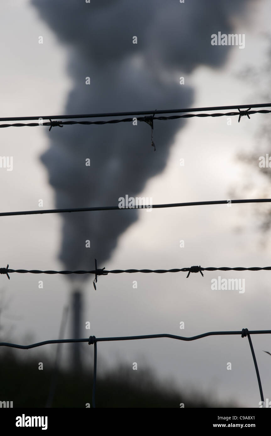 Industrial landscape barbed wire chimney stack smoke Stock Photo - Alamy