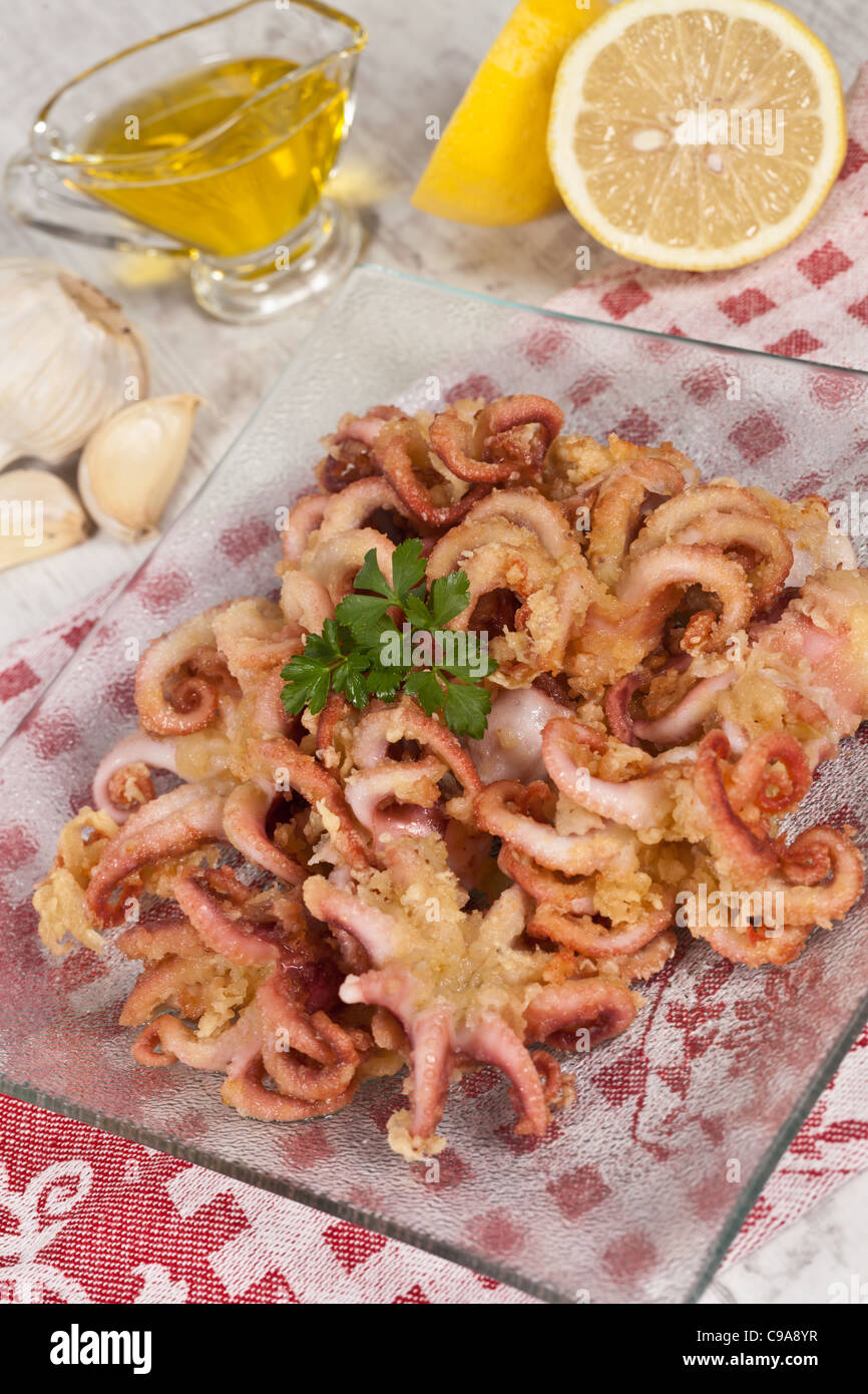 Crusty delicious fried octopus served on a plate Stock Photo - Alamy