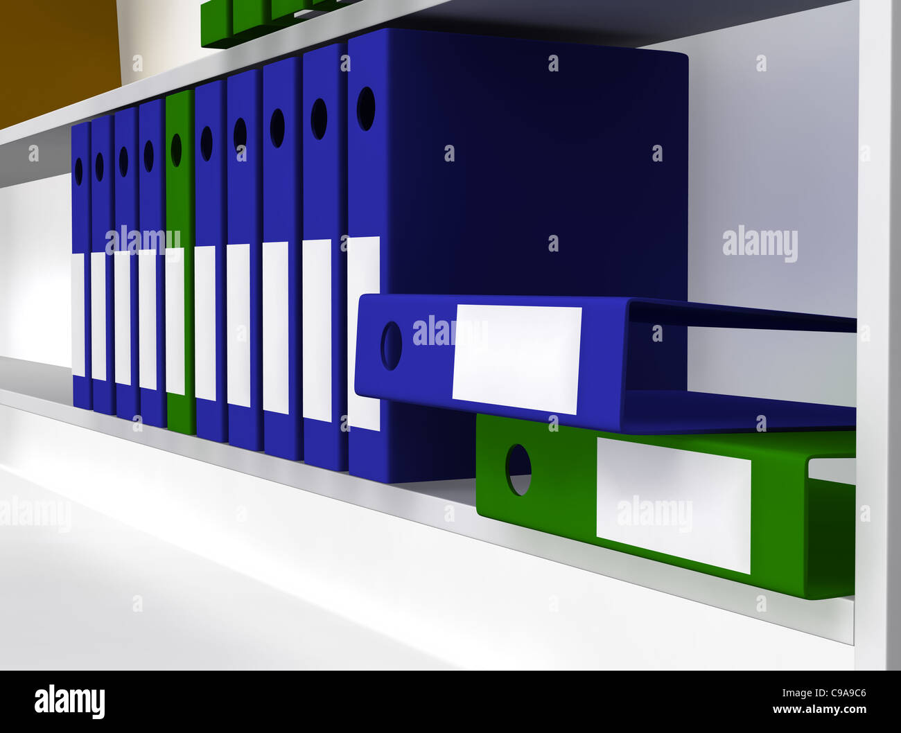 Green and blue folders laying on gray shelf Stock Photo - Alamy
