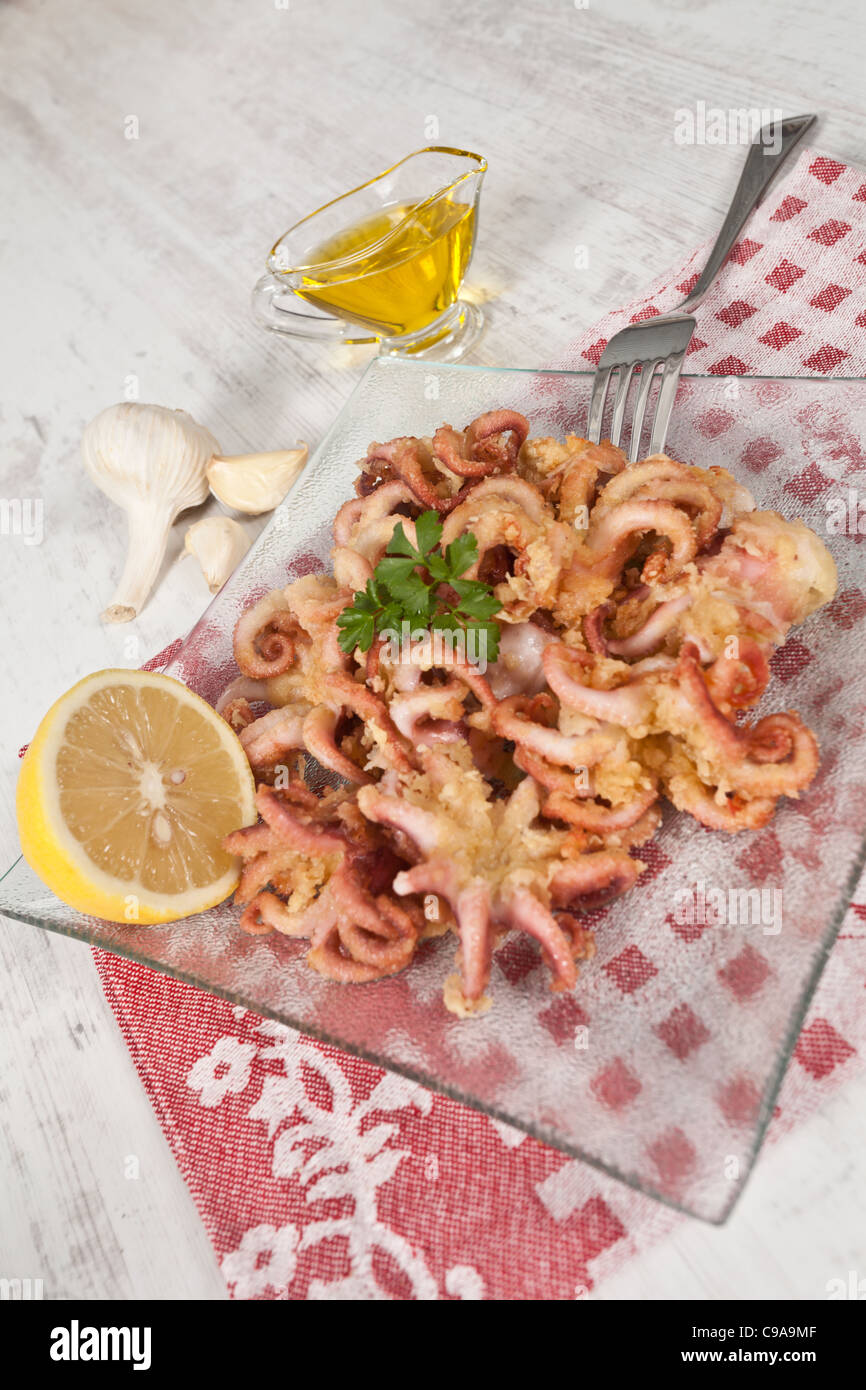 Crusty delicious fried octopus served on a plate Stock Photo - Alamy