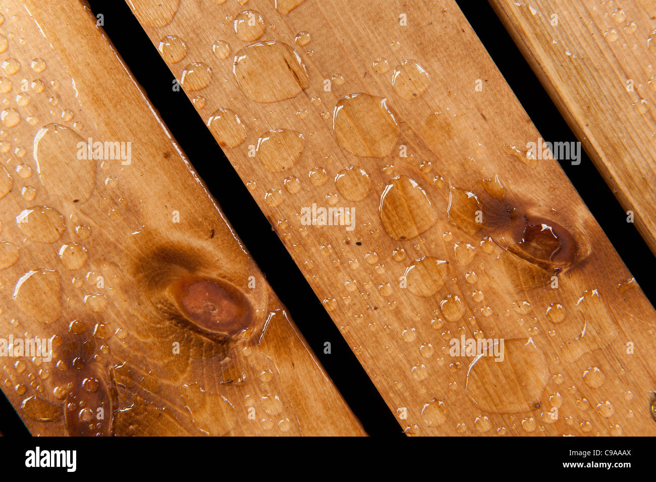 Water droplets on wood timber, protection on decking with active ...