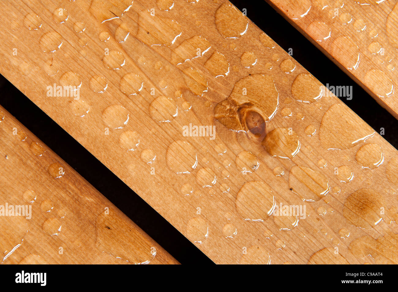 Water droplets on wood timber, protection on decking with active ...
