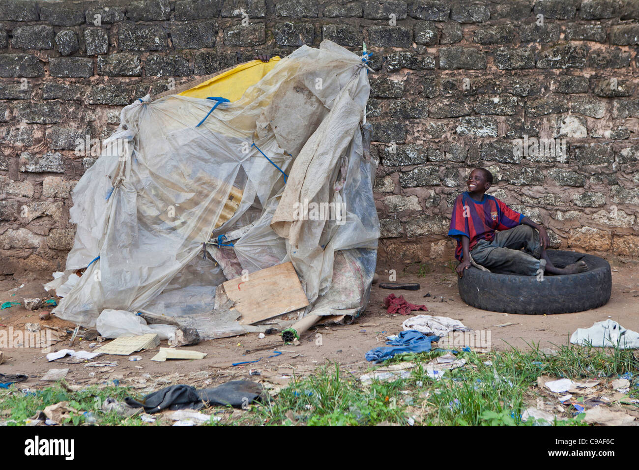 A street boy sits outside the home of one of the Mbaraki base gang ...