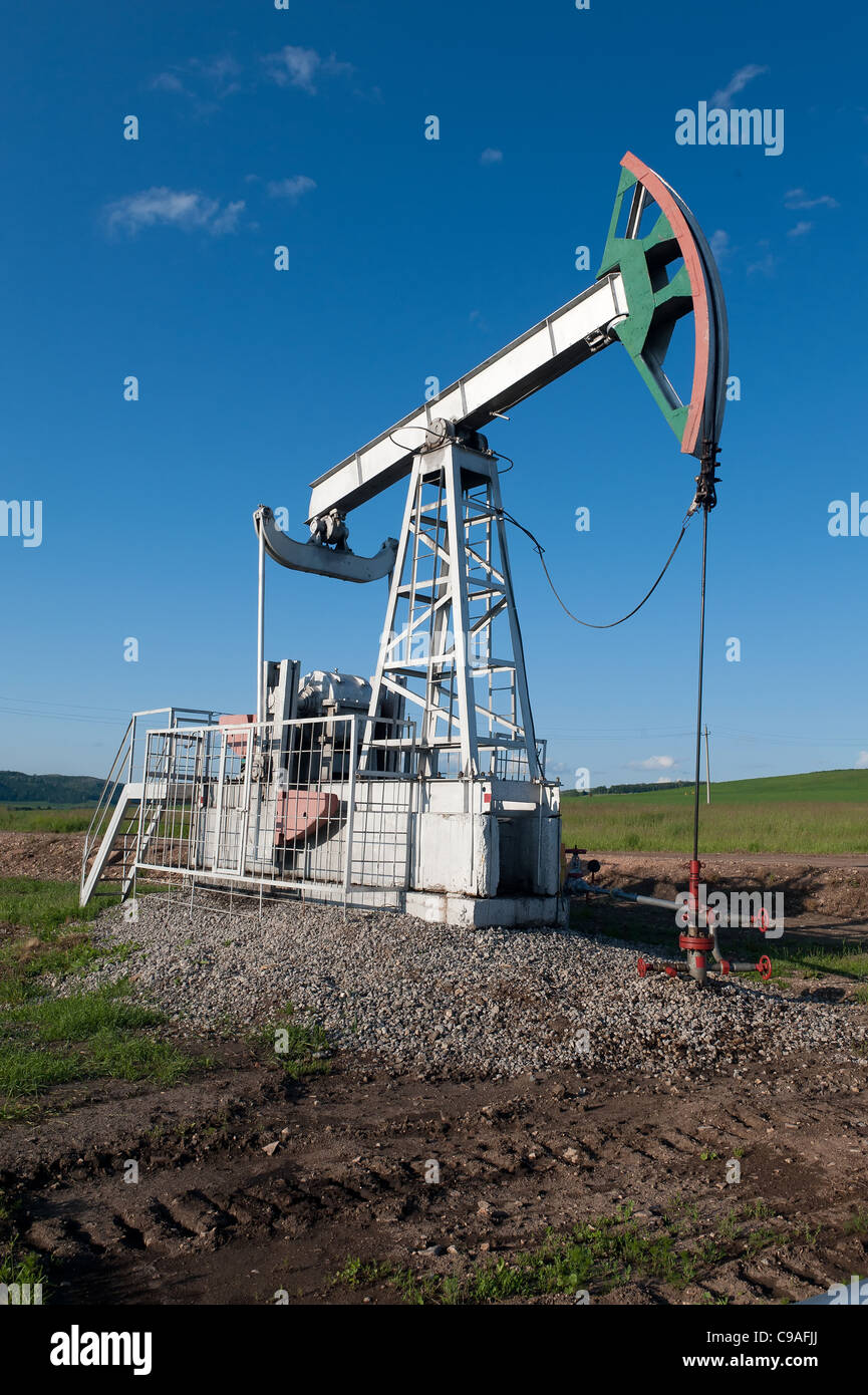 Oil pump on a green field Stock Photo - Alamy