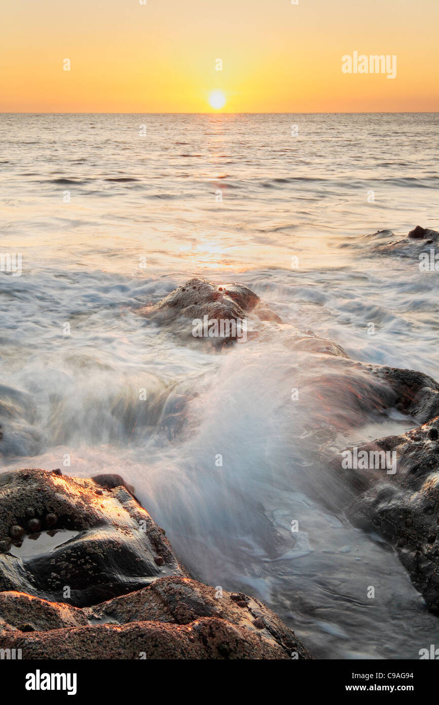 Sun setting on the horizon of the sea Stock Photo - Alamy