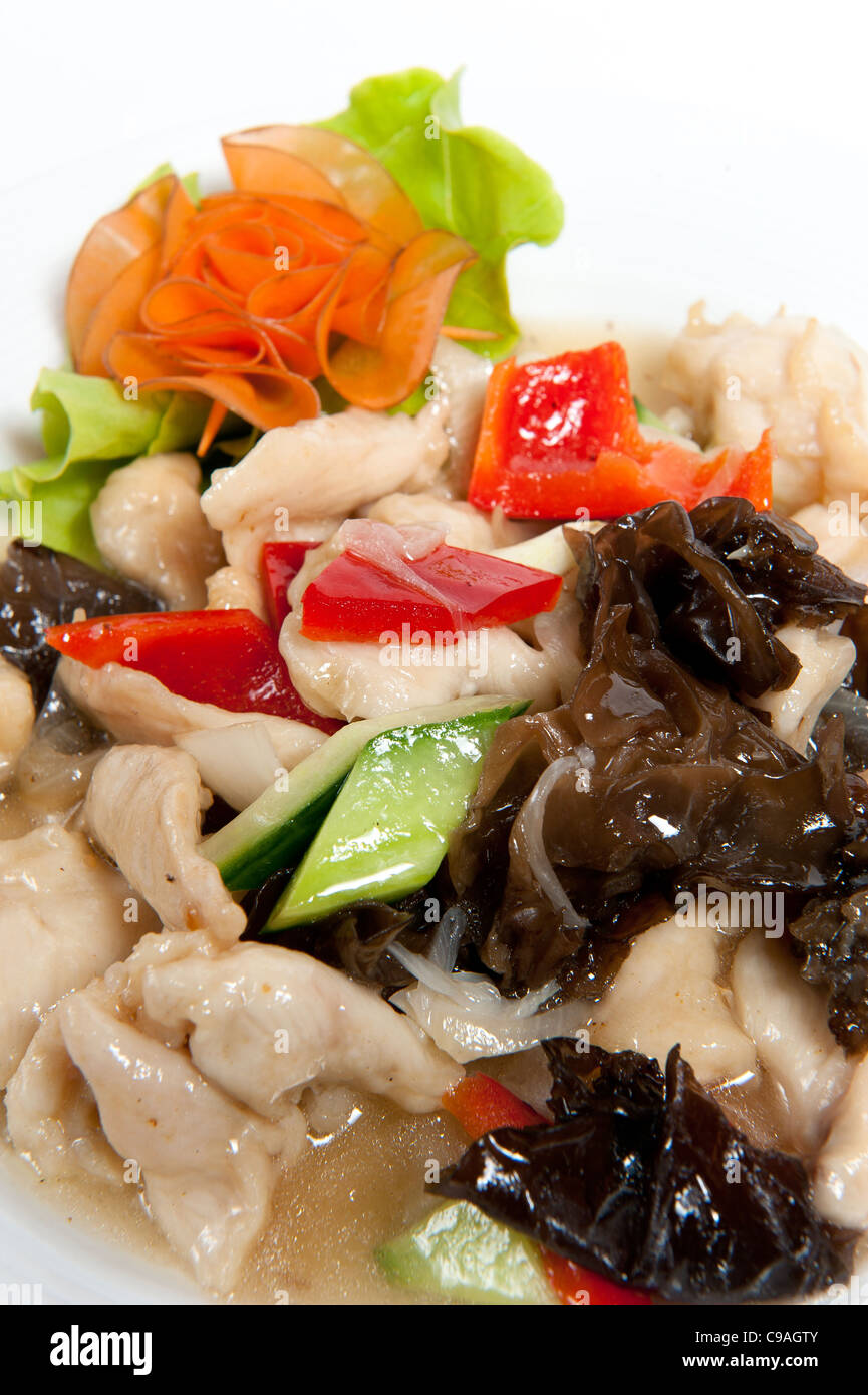 Stewed hen with vegetables on a plate isolated on white background ...