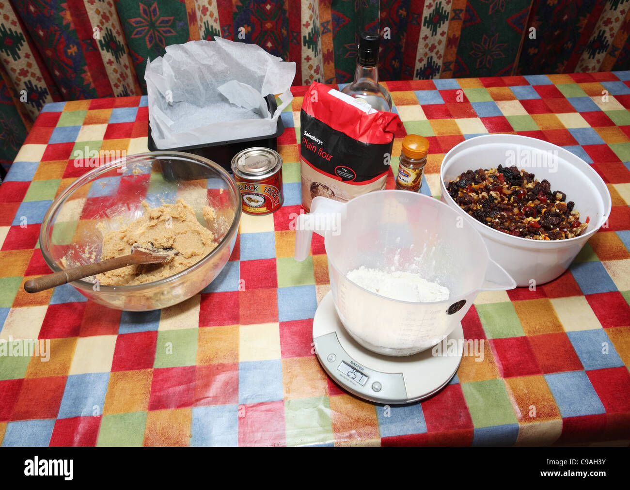 Making a Christmas cake, weighing flour with ingredients and lined ...
