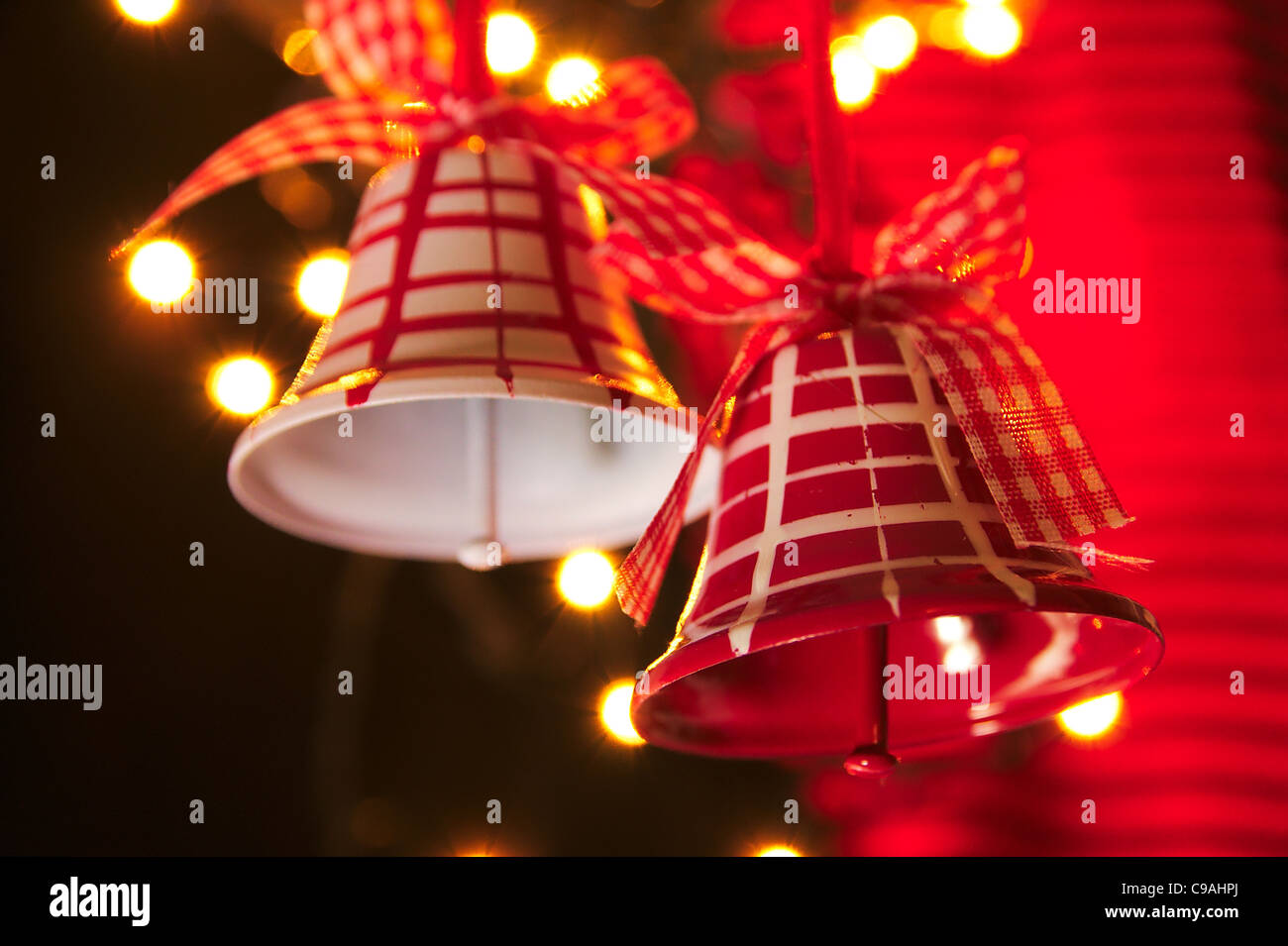 Christmas Bells in Red and White with lights and red background Stock ...