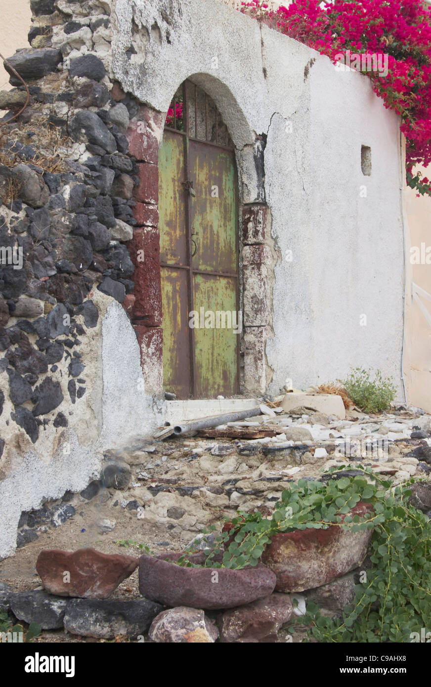 Crumbling wall with distressed green door on the Greek island of ...