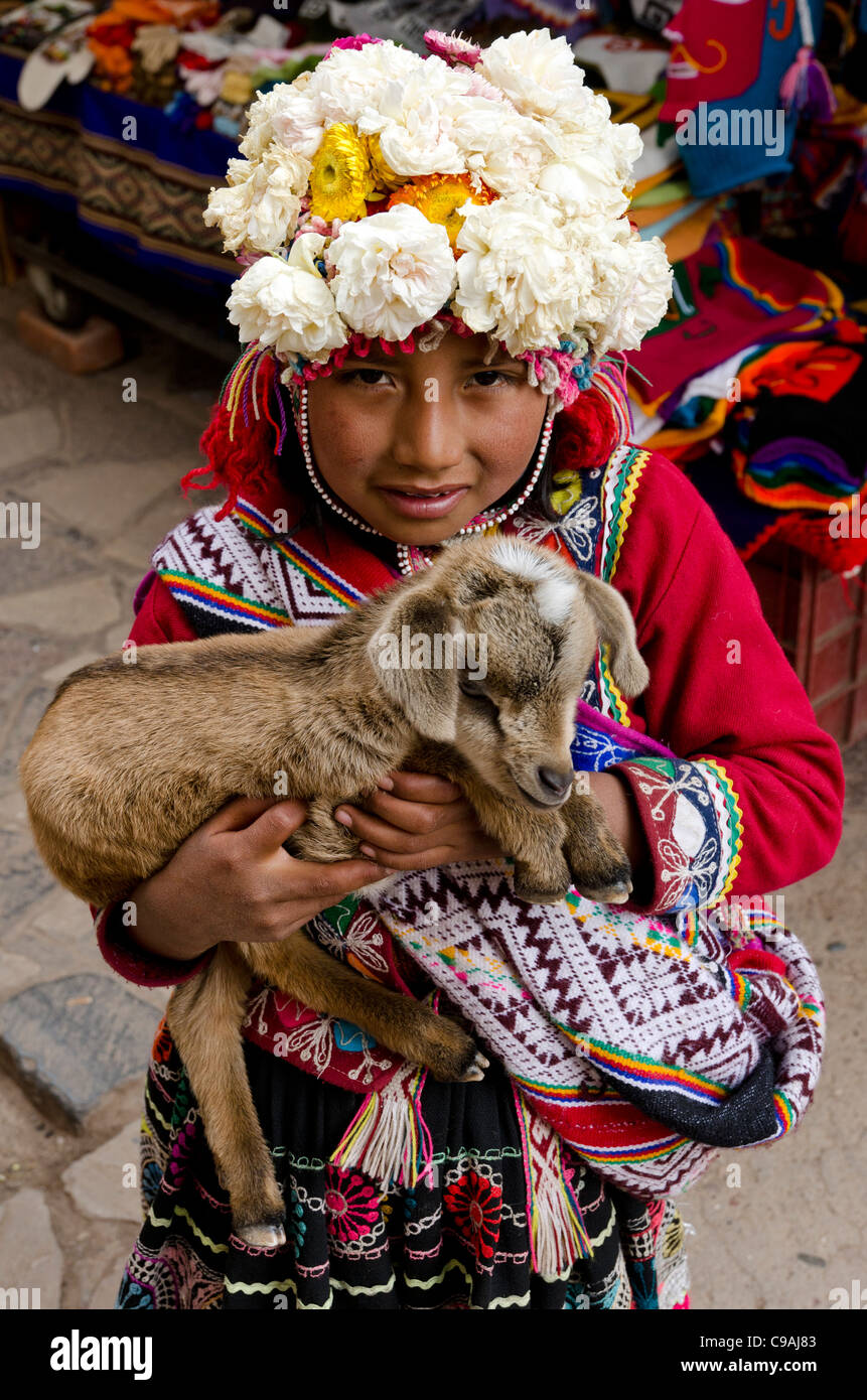 Young girl with lamb wearing traditional Quechua costume in Aguas ...