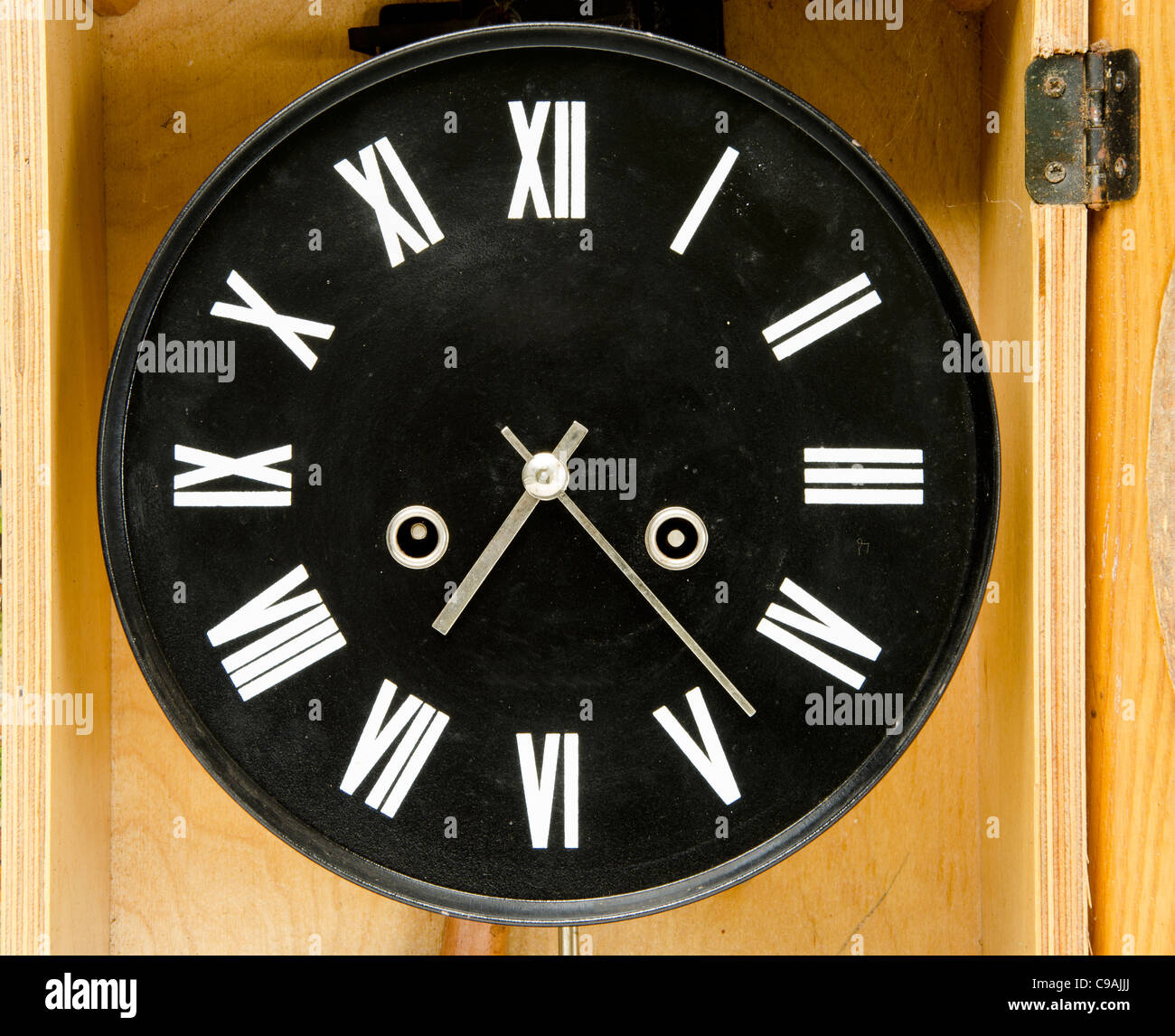 Ancient black clock with roman numbers and arrows. Antique clock in ...