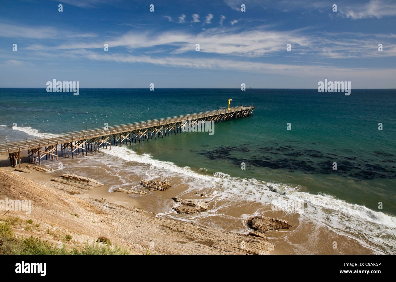 CALIFORNIA - Layered sandstone and dock on the Pacific Coast at Gaviota ...