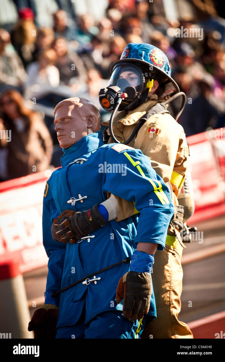 A woman firefighter drags a 175-pound mannequin backwards wearing full ...