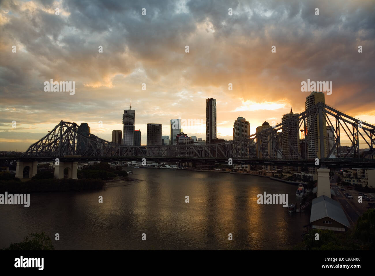 The sun sets behind Brisbane's Story Bridge and city skyline. Brisbane ...
